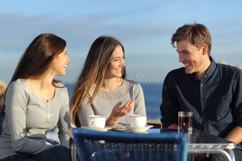 Friends Talking in a Restaurant on the Beach Stock Photo - Image of ...