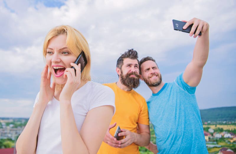 Friends Talking Using Phone at Rooftop. Friends Having Fun on Ro Stock ...