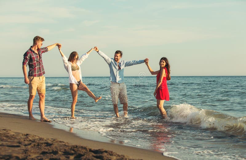 Friends Together on the Beach Having Fun. Stock Photo - Image of ...