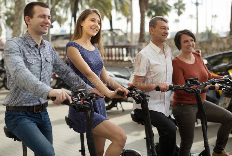 Friends of Tourists of Different Generations Enjoy a Ride on Electric ...