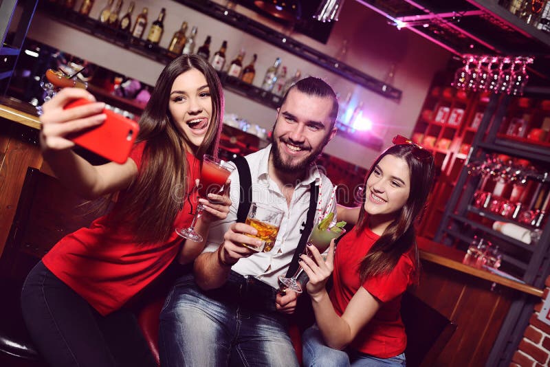 Cute Lesbian Girlfriends Kissing On Bar Background At A Party Stock