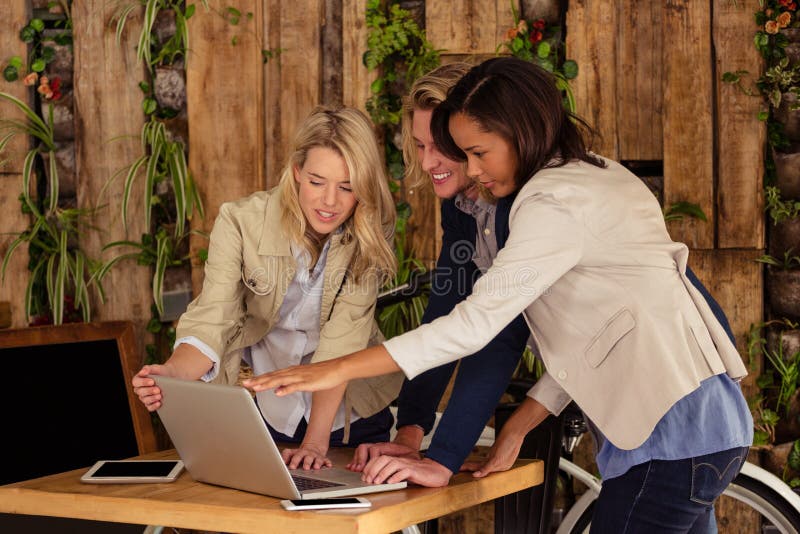 Friends using a laptop stock photo. Image of coffee, friendliness ...