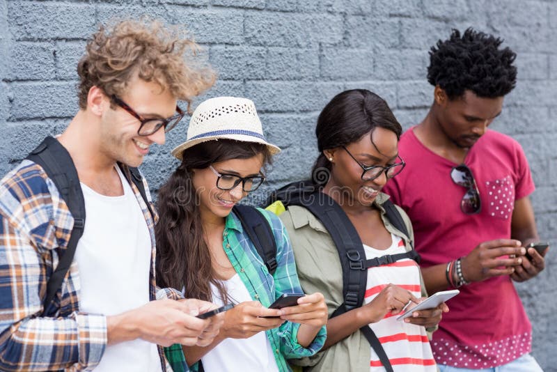 Friends using mobile phone stock photo. Image of bonding - 69803884