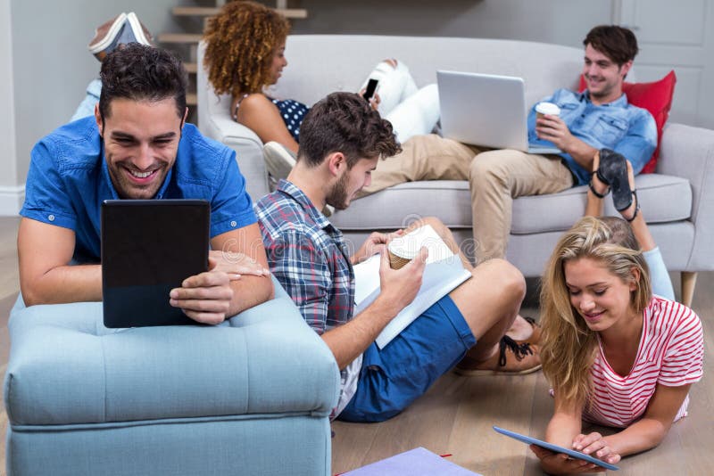 Friends Using Modern Technologies in Living Room Stock Image - Image of ...