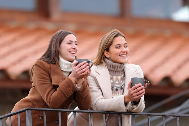 Friends in Winter Talking in a Balcony with Coffee Cups Stock Photo ...