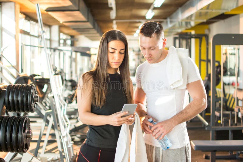 Friends Workout in Gym and Using Smart Phone Stock Photo - Image of ...