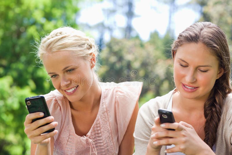 Friends Writing Text Messages in the Park Stock Image - Image of long ...