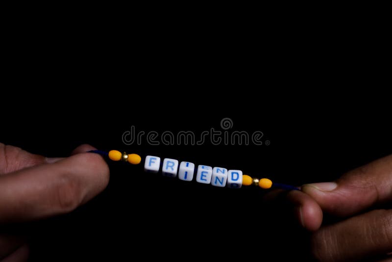 A Friendship Band Held between Two Hands Stock Image - Image of ...