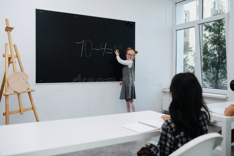 Schoolgirl Solving Maths Formula on Green Board in Classroom Stock ...