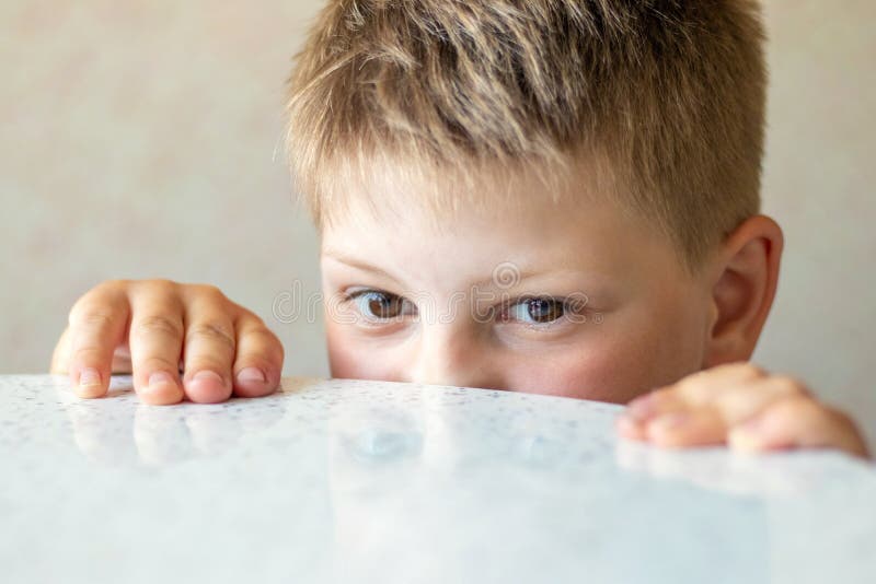 The Frightened Boy Looks Out of the Table Stock Photo - Image of happy ...
