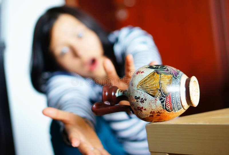 Frightened Female Trying To Catch a Vintage Vase Falling from the Table ...