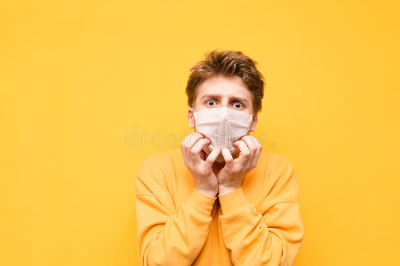 A Frightened Guy In A Protective Mask Is Isolated On A Yellow ...