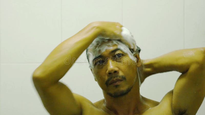 The Front of Asian Men Clean Hair with Shampoo within the Bathroom ...