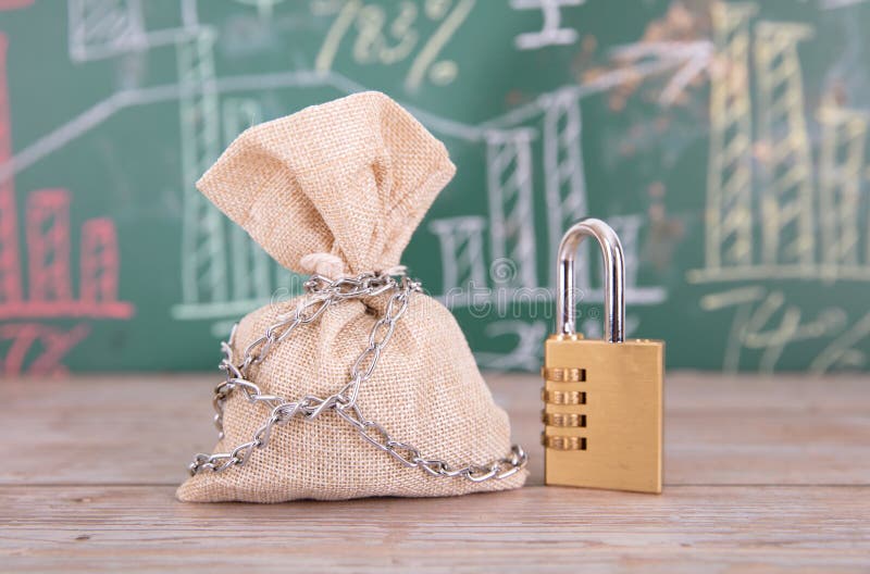 In Front of a Blackboard with Financial Charts, a Money Bag and a ...