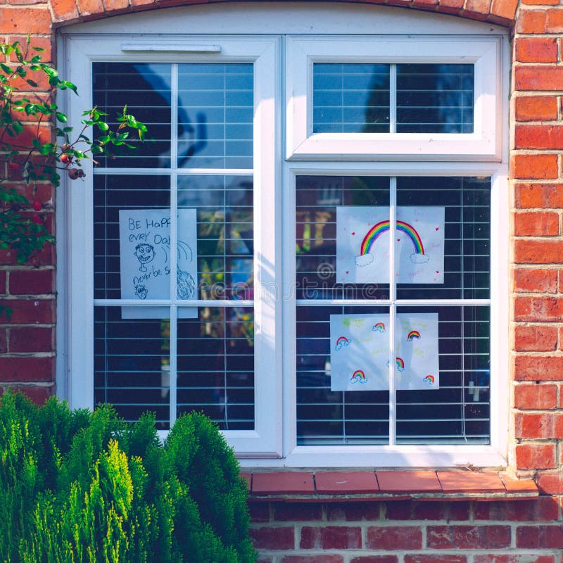The Front of a Brick Building Showing Messages of Stay Home and Save ...