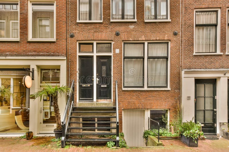 The Front of a Brick Building with Stairs and Windows Stock Photo ...