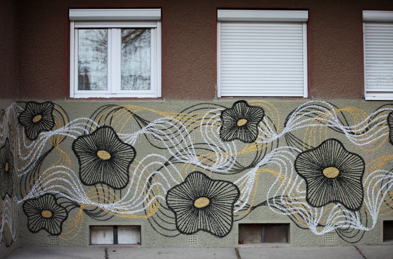 The Front of the Building with White Windows and Graffiti on the Lower ...