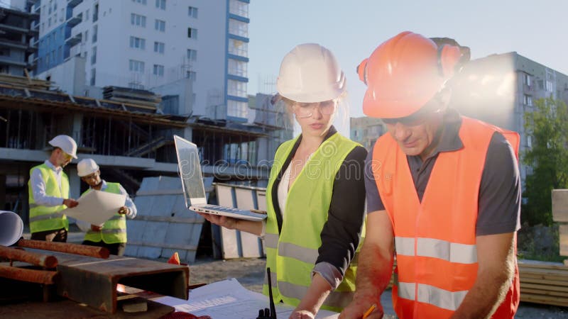 In Front of the Camera Foreman Middle-aged with the Engineer Woman ...
