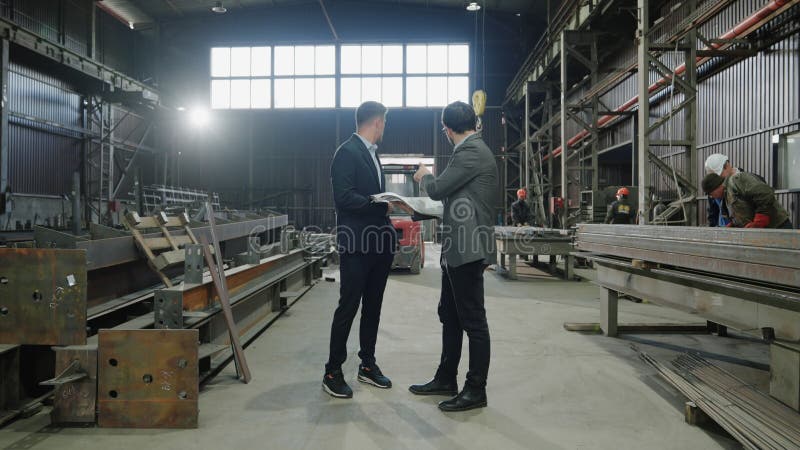 In Front of the Camera Main Engineer and Architect in the Middle of ...