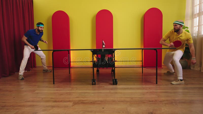 In Front of the Camera Two Good Looking Men Playing the Table Tennis ...