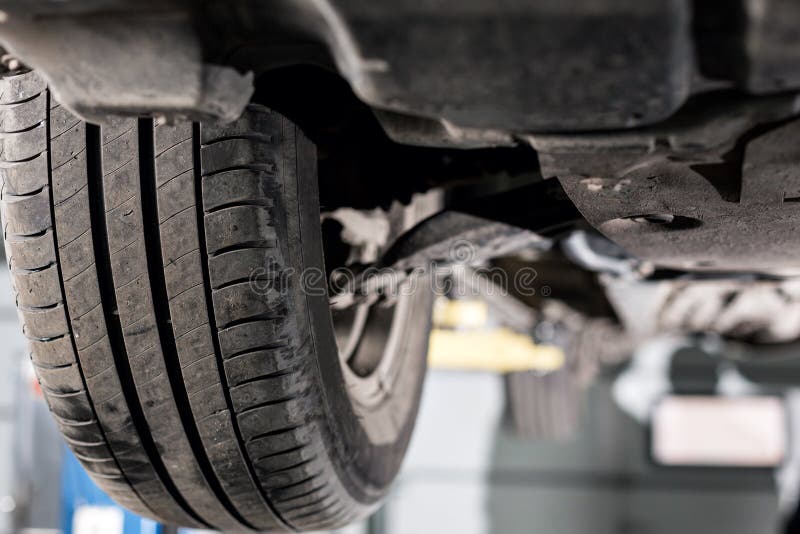 Front Car Suspension. the Garage Mechanic Raised the Car on the Lift ...