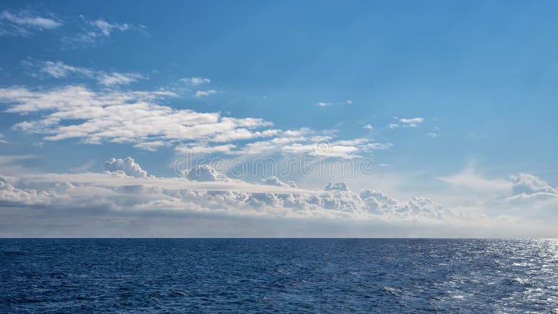 A Front of Cumulus Clouds Over a Shiny Sea Stock Image - Image of ...