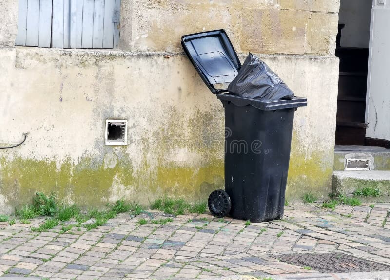 Front Door Open and Dark Grey Waste Bin Filled with Garbage and Plastic ...