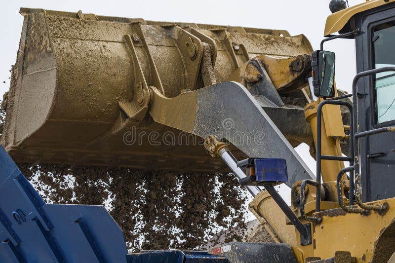 A Front End Loader Machine Tipping Sand in a Stock Image - Image of ...
