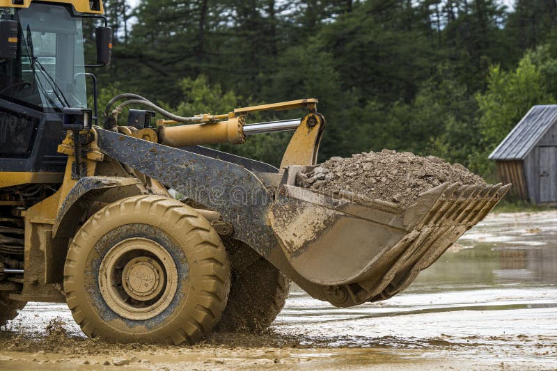 A Front End Loader Machine Tipping Sand in a Stock Image - Image of ...