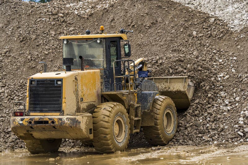 A Front End Loader Machine Tipping Sand in a Stock Image - Image of ...