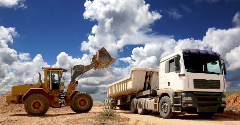 Front End Loader Tipping Stone Stock Photo - Image of large, earth ...