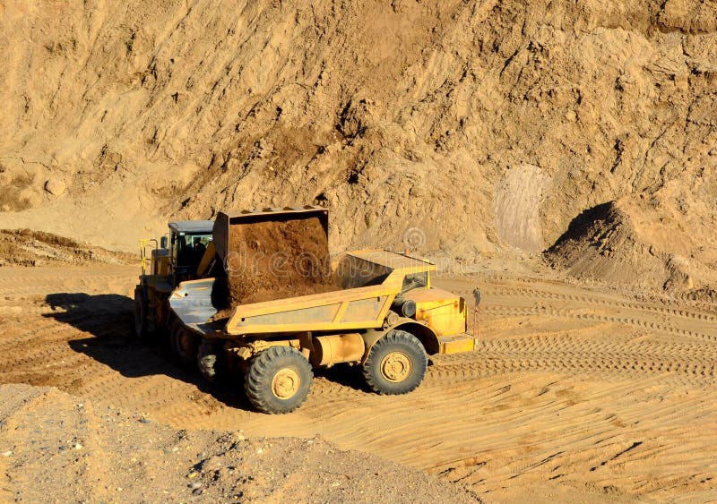 Front-end Loader Loading with Sand a Heavy Dump Truck Stock Photo ...