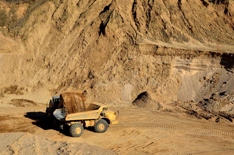 Front-end Loader Loading with Sand a Heavy Dump Truck in a Quarry Stock ...