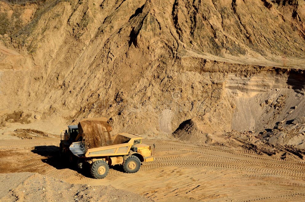 Front-end Loader Loading with Sand a Heavy Dump Truck in a Quarry Stock ...