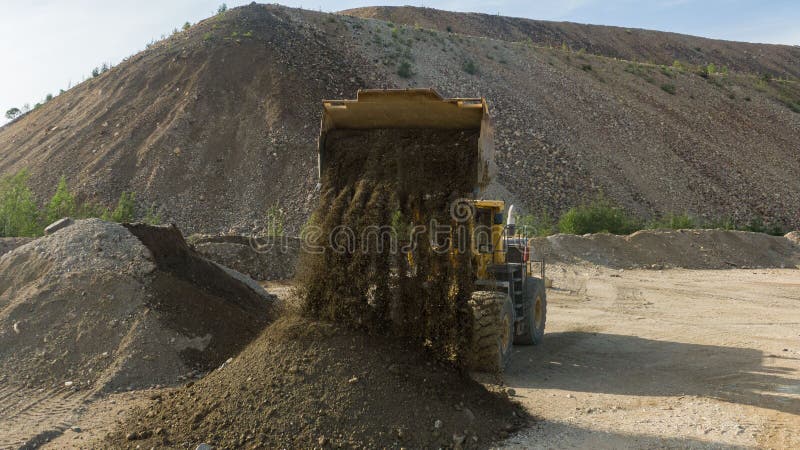 A Front End Loader Machine Tipping Sand in a Stock Photo - Image of ...