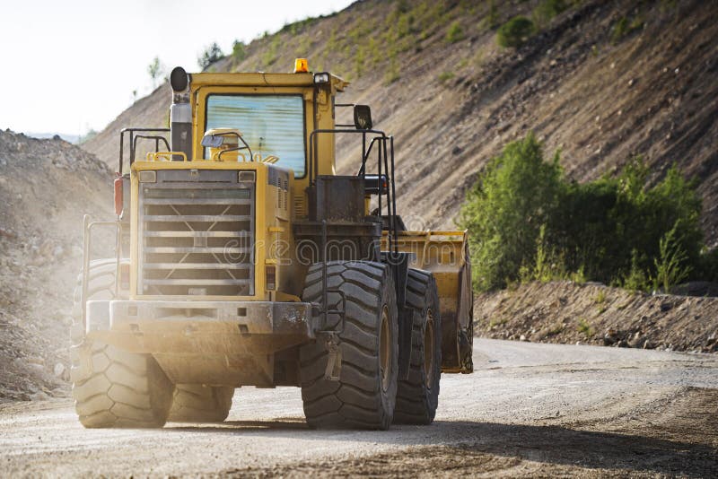 A Front End Loader Machine Tipping Sand in a Stock Image - Image of ...