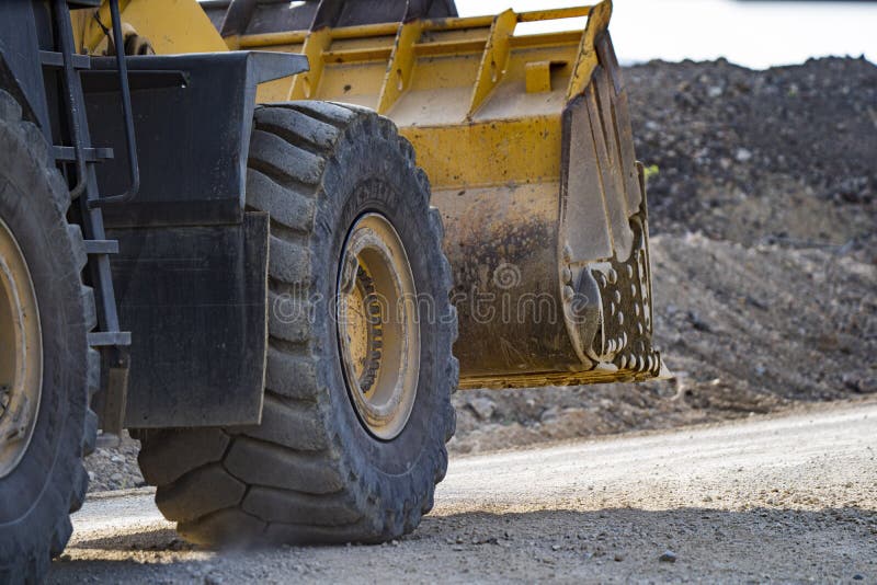 A Front End Loader Machine Tipping Sand in a Stock Image - Image of ...