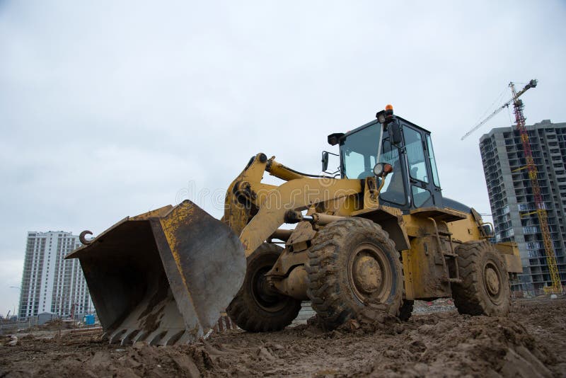 Front-end Loader Working at Construction Site. Earth-moving Heavy ...