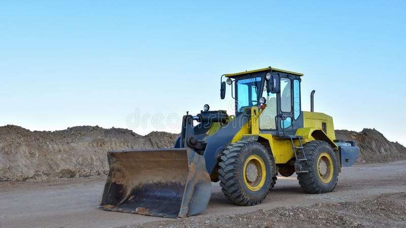 Front-end Loader Working at Construction Site. Earth-moving Heavy ...