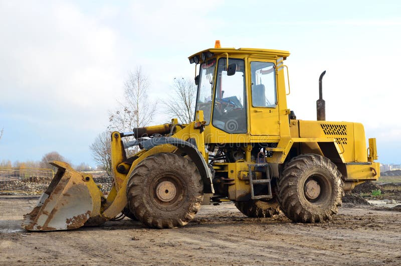 Front-end Loader Working at Construction Site. Earth-moving Heavy ...