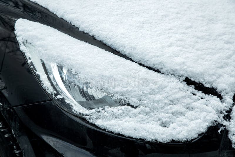 Front Halogen Headlight of a Black Car Covered with a Layer of Snow ...