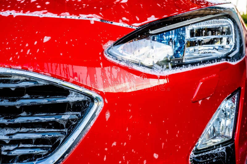 Front Headlight and Grille of a Red Car Being Washed.. Stock Image ...