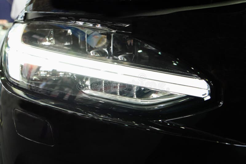 Front Illuminated Headlights of a Black Luxury Modern Car. Close Up ...