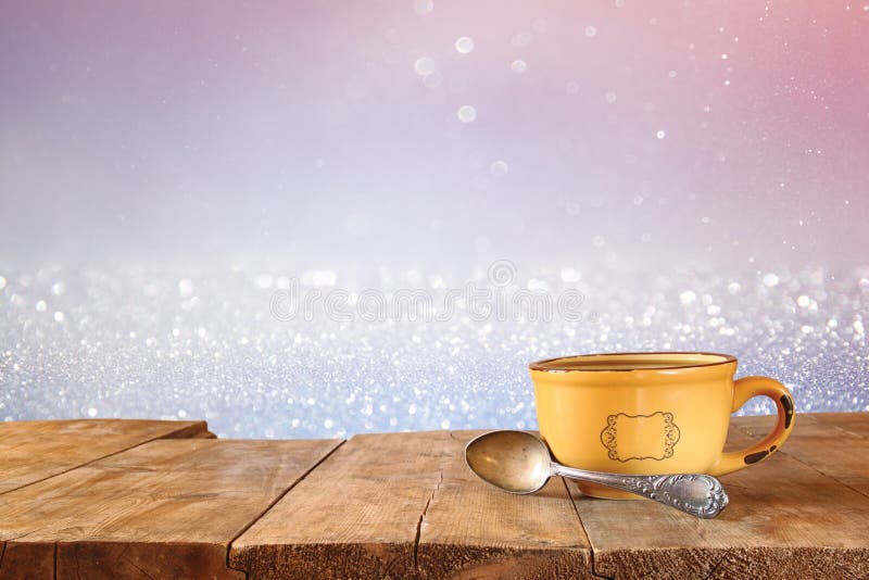Front Image of Coffee Cup Over Wooden Table in Front of Glitter ...