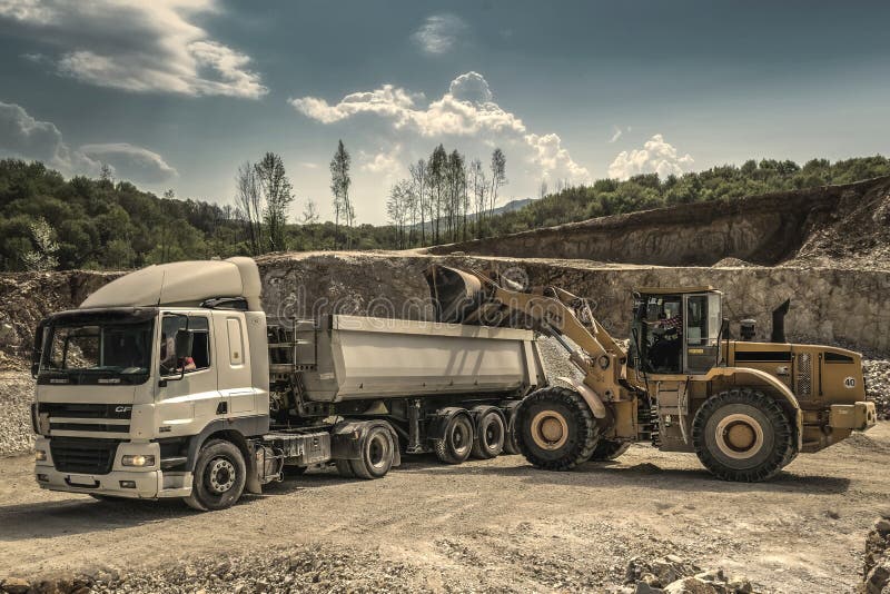 Front Load Loader Beside White Dump Truck Stock Image - Image of drive ...