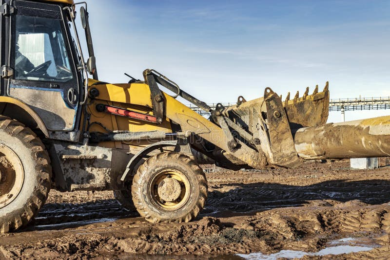 A Front Loader or Bulldozer Transports a Large Pipe To a Construction ...