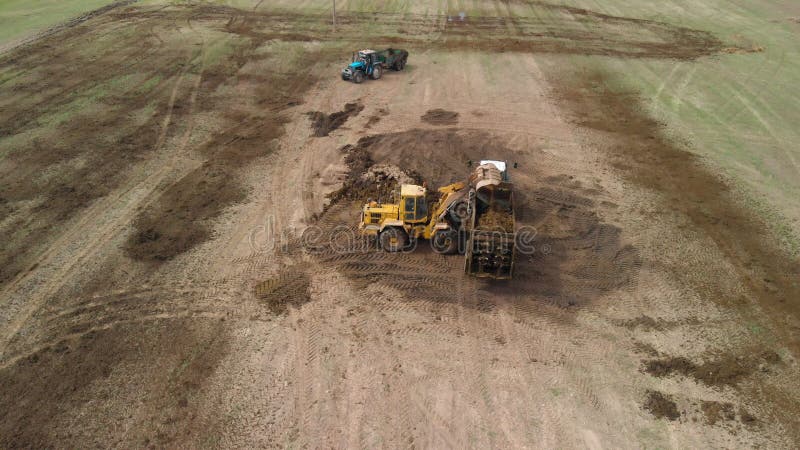 Loader Fills the Tractor S Manure Spreader in the Field Stock Video ...