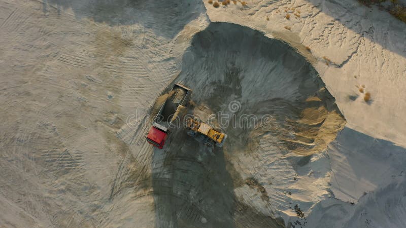 Front Loader Loading Crushed Stone into Dump Truck in Quarry, Aerial ...