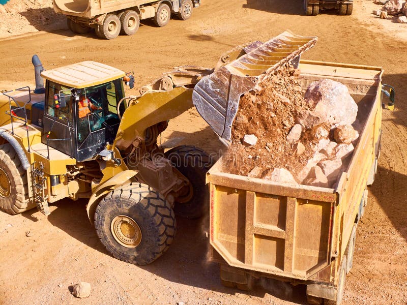 Front Loader Loads Rock into a Dump Truck Stock Photo - Image of rock ...