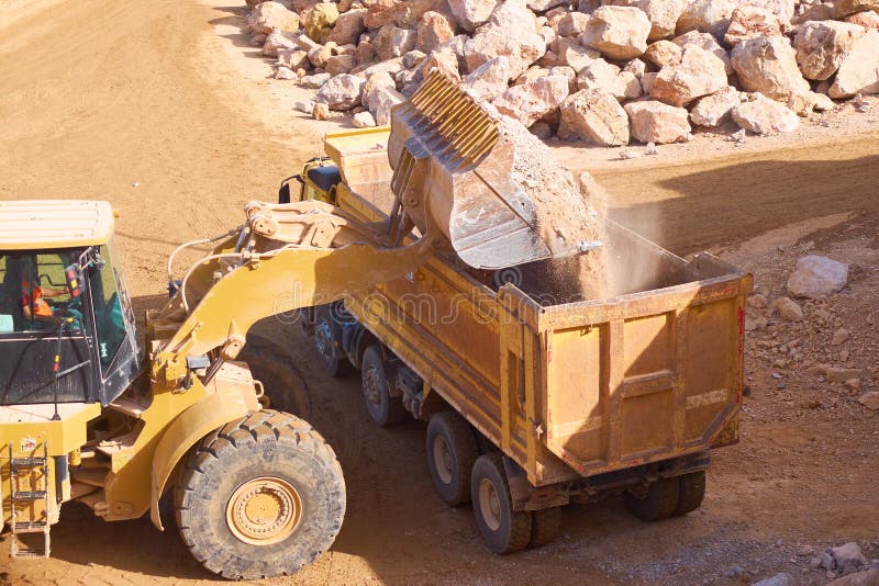 Front Loader Loads Rock into a Dump Truck Stock Image - Image of ...